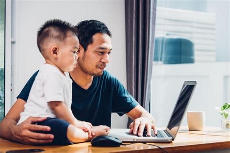 Premium Photo Man Father Working On Laptop Computer With Son From Home
