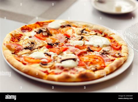 Pizza With Mozzarella Cheese Fresh Tomato And Mushrooms Served At
