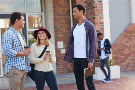 Catching Up Before Class Cropped Shot Of A Group Of University