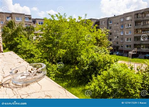 Glass Ashtray With Cigarette Butts On The Balcony Railing Stock Image