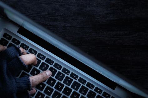 premium photo hacker hand pointing finger on laptop screen