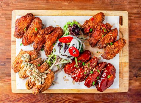 Fried Chicken Wings Platter With Salad Servedon Cutting Board Isolated