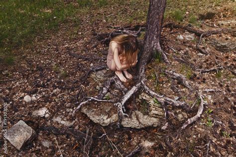 Girl Sitting Near Tree Roots The Girl Hid Her Face Under Hair A Girl With Bare Feet Sad Mood