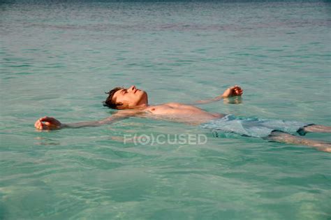 Man Floating In Tropical Water To Years Nature Stock Photo
