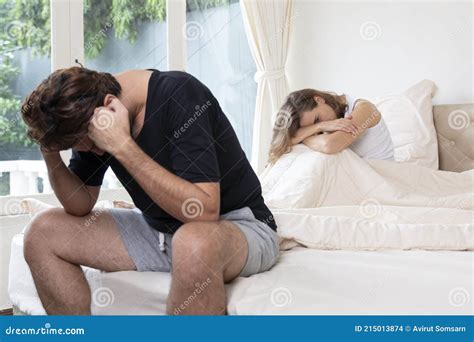 Women Focus Depressed Man Sitting On The Edge Of The Bed In Bedroom