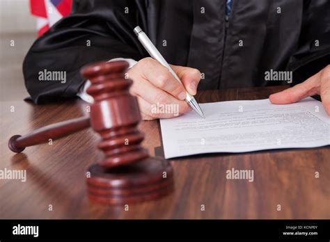 Close Up Of Male Judge Writing On Paper In Courtroom Stock Photo Alamy