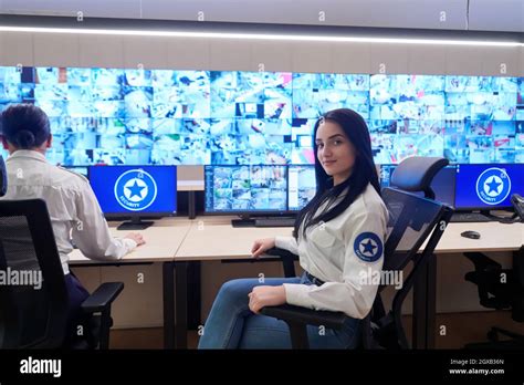 Portrait Of Female Security Operator While Working In A Data System Control Room Offices
