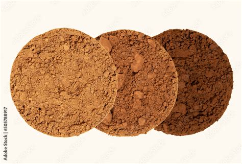 Alternative Type Of Processed Cocoa Three Piles Of Cocoa Powder Of Different Colors On A Beige