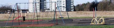 Empty Play Area In Council Estate And High Rise Flats In Background