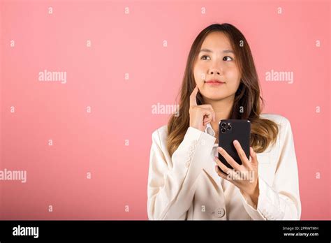 Young Woman Excited Smiling Holding Mobile Phone And Think Idea Finger