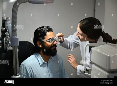 Optometrist Doing Sight Testing For Male Patient With Special