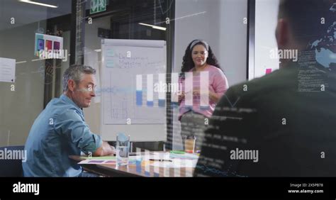 image of graphs globes computer language over diverse coworkers