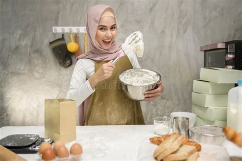 Young Beautiful Muslim Woman Is Baking In Her Kitchen Bakery And Coffee Shop Business Stock