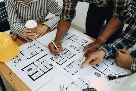 Architect And Engineer Team Working With Blueprints For Architectural