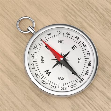 Premium Photo Silver Compass On Wooden Table
