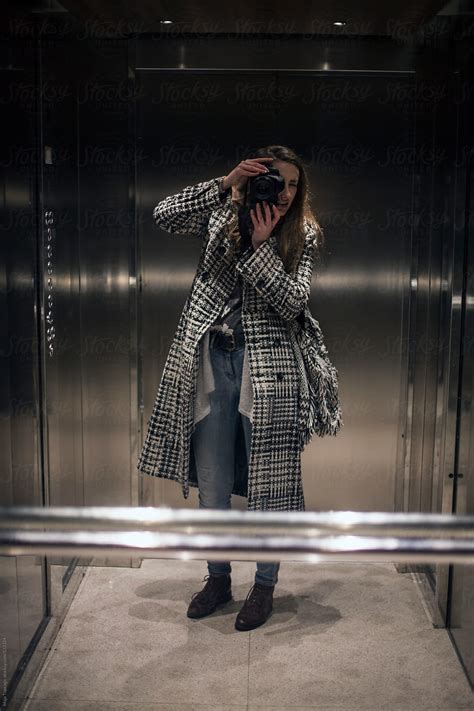 Young Woman With A Camera In An Elevator By Stocksy Contributor Maja