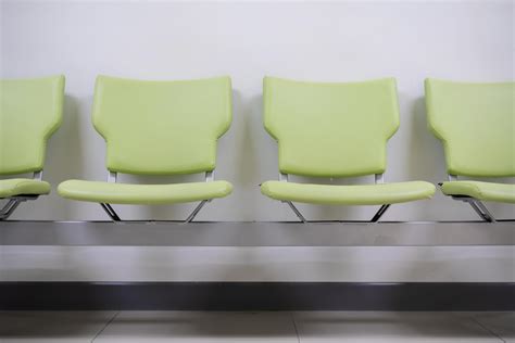 Row Of Green Office Chairs Standing In Corridor Or Conference Room