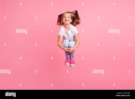 Full Size Portrait Of Crazy Overjoyed Person Hands Hold Legs Jumping Fall Isolated On Pink Color