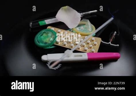 Condoms And Birth Control Pills On A White Background Stock Video