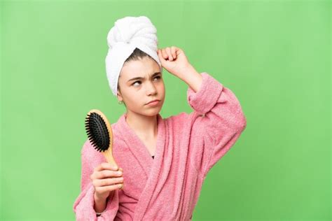 Premium Photo Young Girl With Hair Comb Having Doubts And With