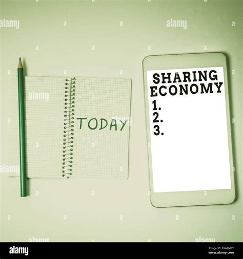 Sign Displaying Sharing Economy Word Written On A System Where Assets Are Shared Privately