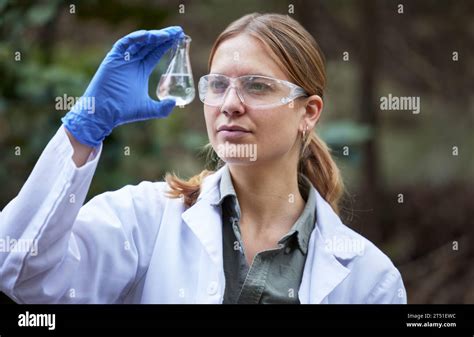 Water Research And Woman Scientist Test In A Forest For Inspection Of The Ecosystem Sample Or