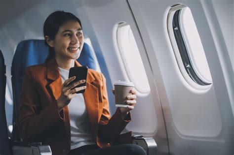 Premium Photo Traveling And Technology Flying At First Class Pretty Young Businees Woman Using