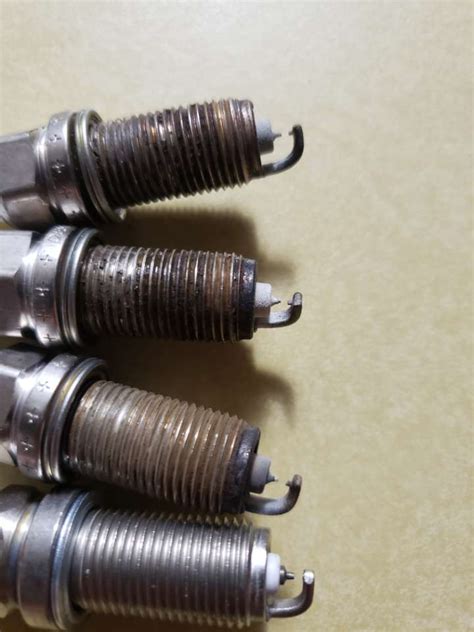 Engine misfiring and shaking. How bad do the three old spark plugs in this picture look? : r ...