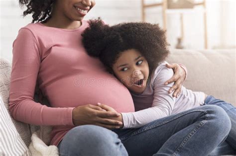 Little Girl Hugging Her Mother's Pregnant Belly Stock Photos - Free & Royalty-Free Stock Photos ...