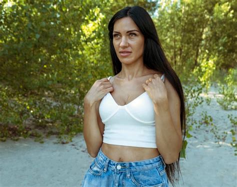 Premium Photo Young Longhaired Brunette Woman In A White Tank Top And