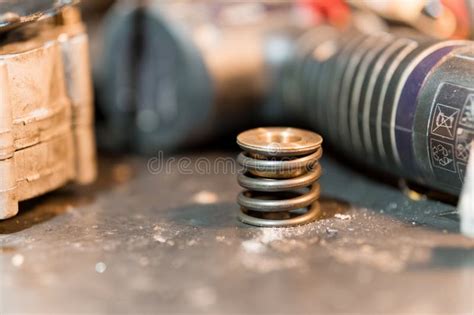 Close Up Of A Metal Compression Spring On A Workbench Surrounded By Tools Stock Image Image Of