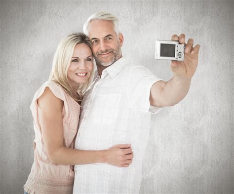 Premium Photo Happy Couple Posing For A Selfie Against Weathered Surface