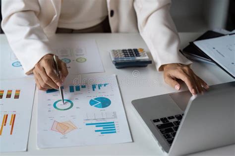 Professional Business Analysis With Graphs And Charts On Office Desk Featuring Laptop And