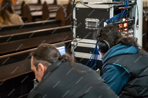 Premium Photo A Sound Engineer With Headphones Sits In Front Of A