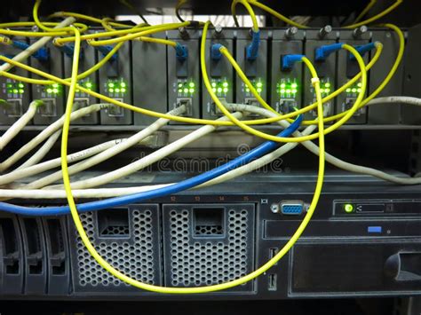 close up network cables connected to switch in server rack stock image