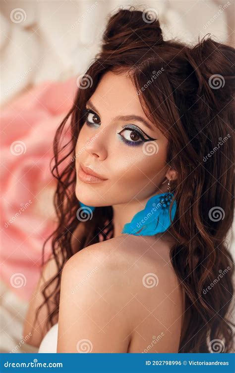Beauty Fashion Model Girl With Creative Art Makeup And Blue Feather