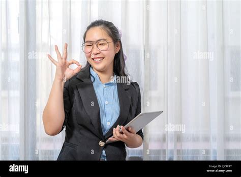 Ok Gesture Poses From An Asian Beauty Woman With A Tablet Computer