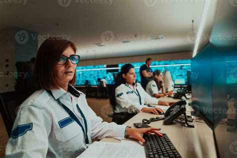Group Of Female Security Operators Working In A Data System Control Room Technical Operators