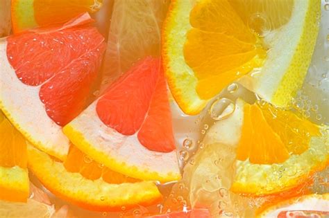 물 배경에서 자몽 오렌지 과일 꿀 포멜로 조각의 클로즈업 보기 유리 벽에 매크로 거품이 있는 냉각 과일 음료의 질감 플랫 디자인