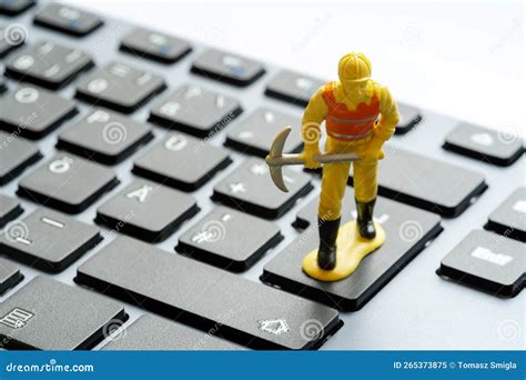 construction worker figurine with a pickaxe standing on top of a simple