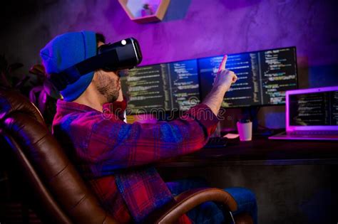 Photo Of Dreamy Excited Programmer Wear Spectacles Pointing Finger Modern Device Indoors