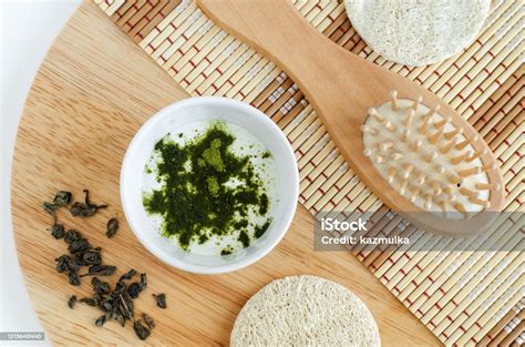 말차 가루를 곁들인 신선한 요구르트는 작은 흰색 그릇과 나무 헤어 브러시 홈 메이드 자연 미용 트리트먼트 얼굴 또는 헤어 마스크와 스파 조리법 상단 보기 복사 공간 0명에