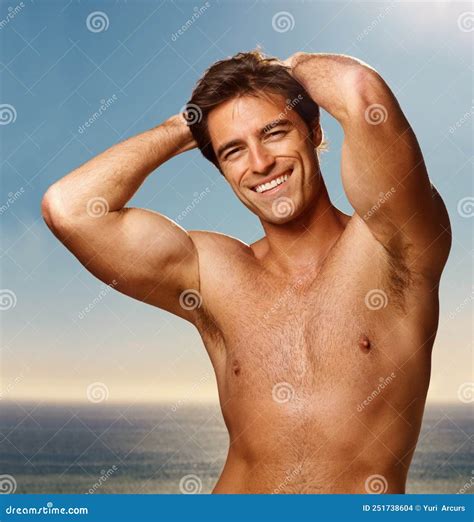A Shirtless Man Posing And Smiling By The Sea Portrait Of A Happy Handsome Shirtless Man Posing
