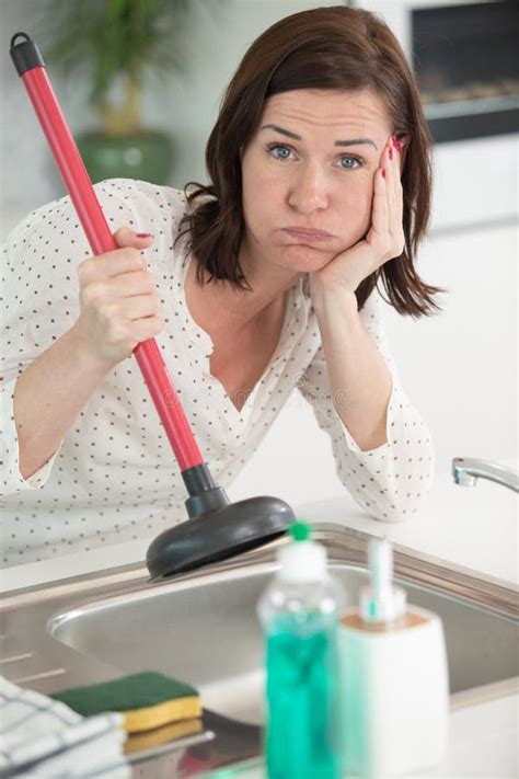 Young Unhappy Woman Using Plunger In Clogged Sink Stock Image Image