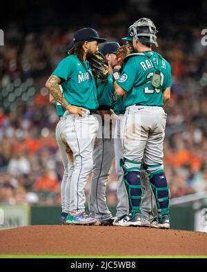 Seattle Mariners Catcher Cal Raleigh Stands In The Dugout Before A