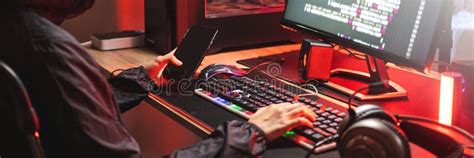 Dangerous Hooded Hacker Typing Bad Data Into Computer Online System And