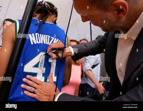 Naismith Memorial Basketball Hall of Fame 2023 inductee Dirk Nowitzki autographs a jersey after ...