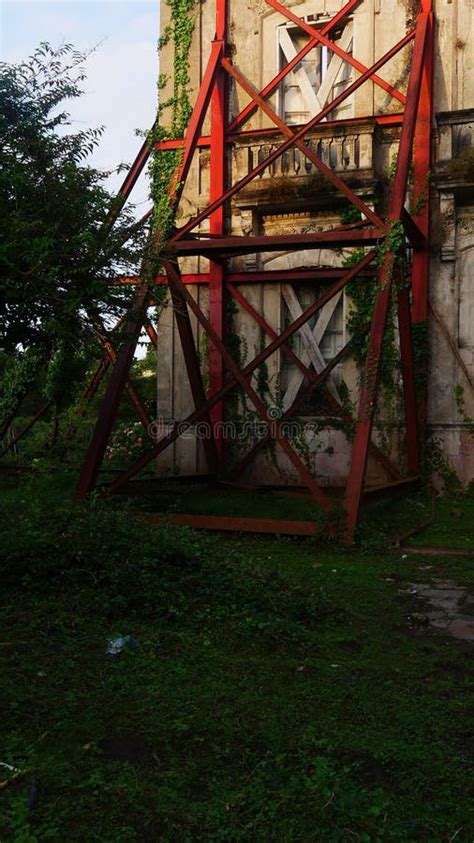 Metal Beam Support Structure For A Crumbling Wall With Ivy Growth