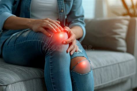 Close Up Of A Woman Holding Her Painful Knee Depicting Symptoms Of