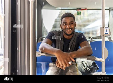 Portrait Of A Happy African Man Sitting On The Public Bus On The Way To